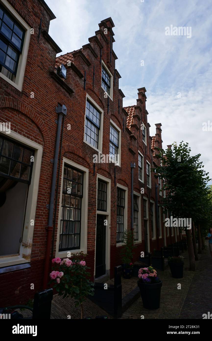 A row of typical traditional Dutch old fashioned gable roof brick ... A row of typical traditional Dutch old fashioned gable roof brick ...