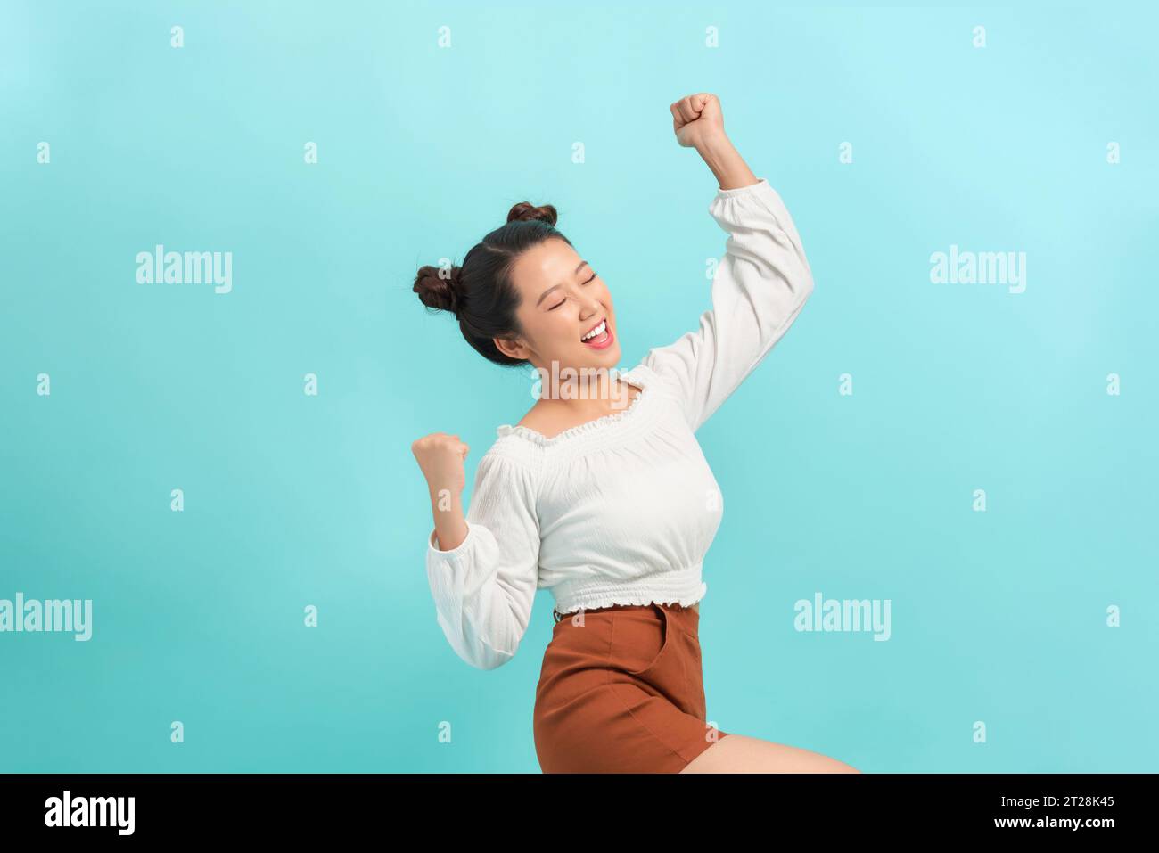 Beautiful girl act like a telling something Isolated on light blue ...