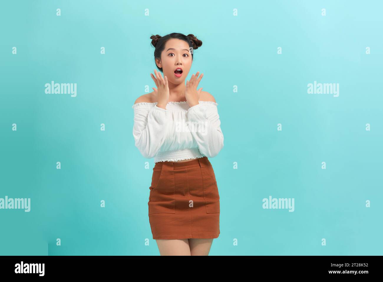 Beautiful girl act like a telling something Isolated on light blue ...