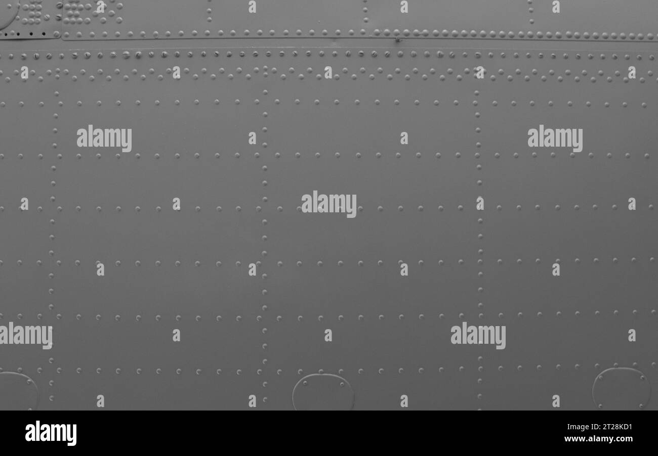 Aircraft skin close up. Rivets on gray metal. Aluminum surface of the ...