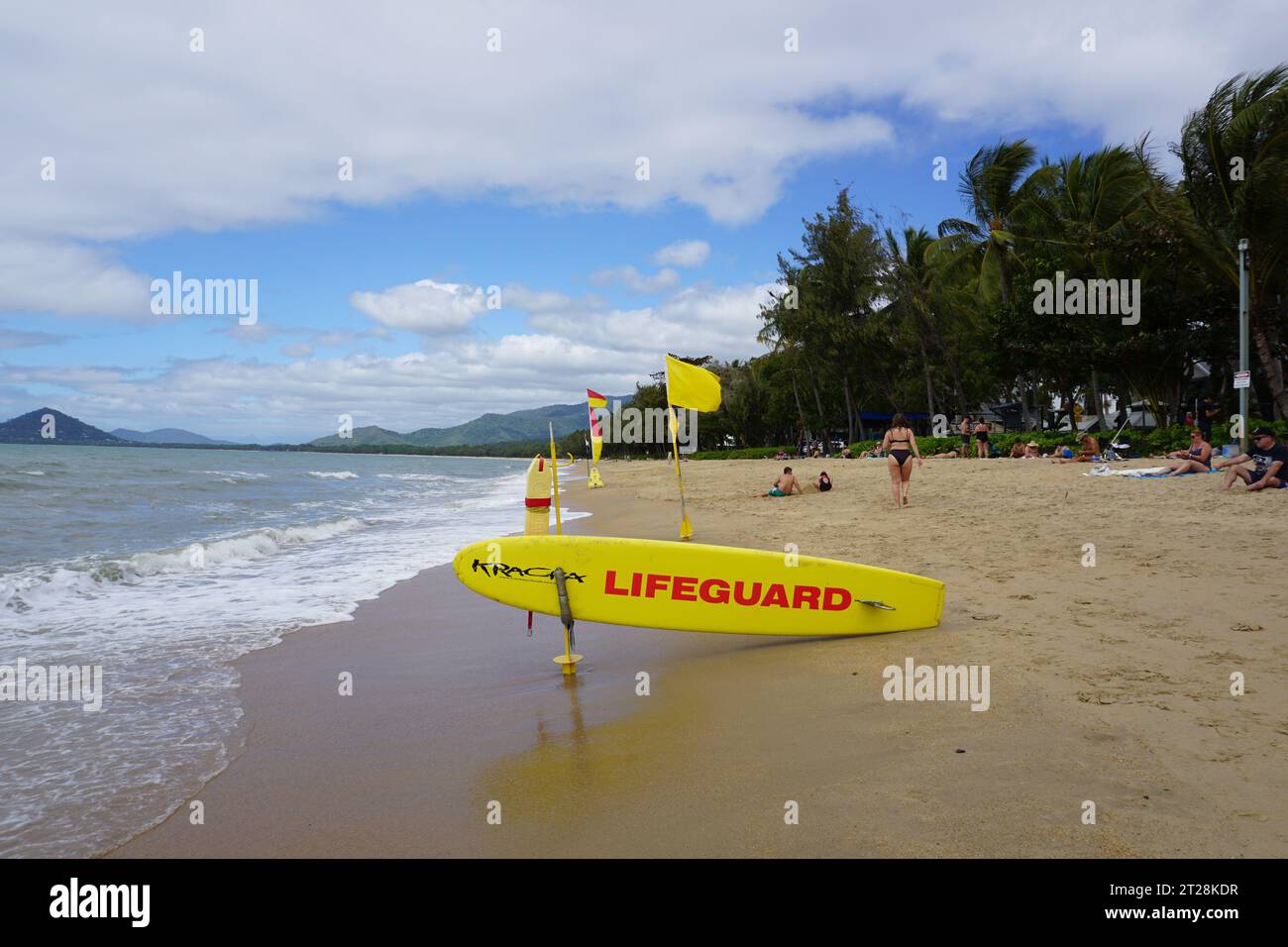 Lifeguard surfboard and flags on beach in palm cove, queensland ...