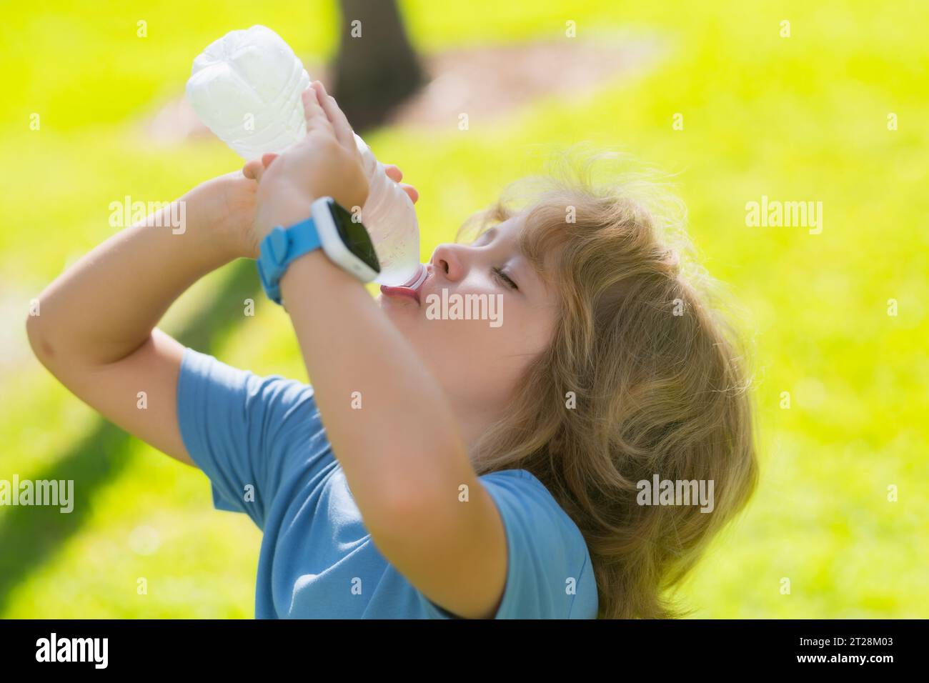 Child drinking water. Kid enjoy pure fresh mineral water. Outdoor kid ...
