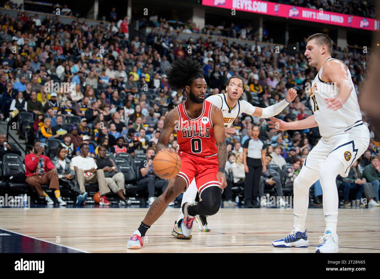 Chicago Bulls guard Coby White drives past Denver Nuggets forward Aaron ...