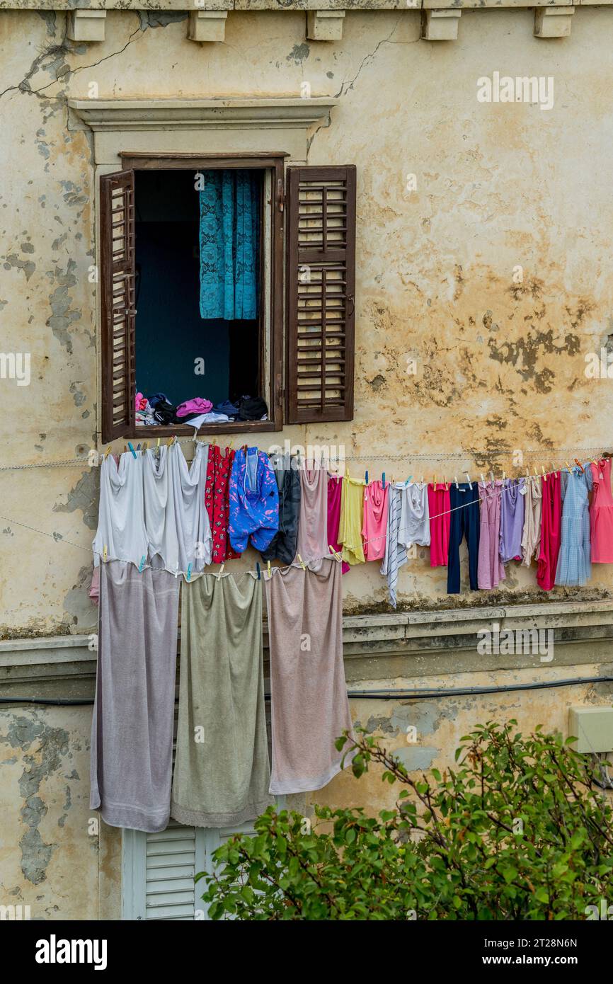 View from the city wall walk of laundry drying outside a window in the ...