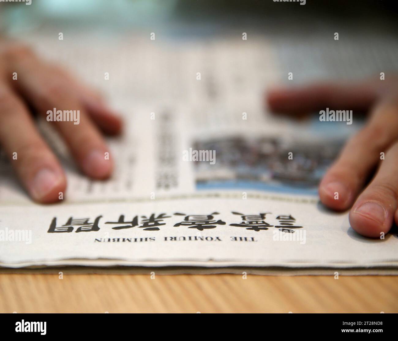 A man reads a Japanese newspaper, The Yomiuri Shimbun in Tokyo on Oct ...