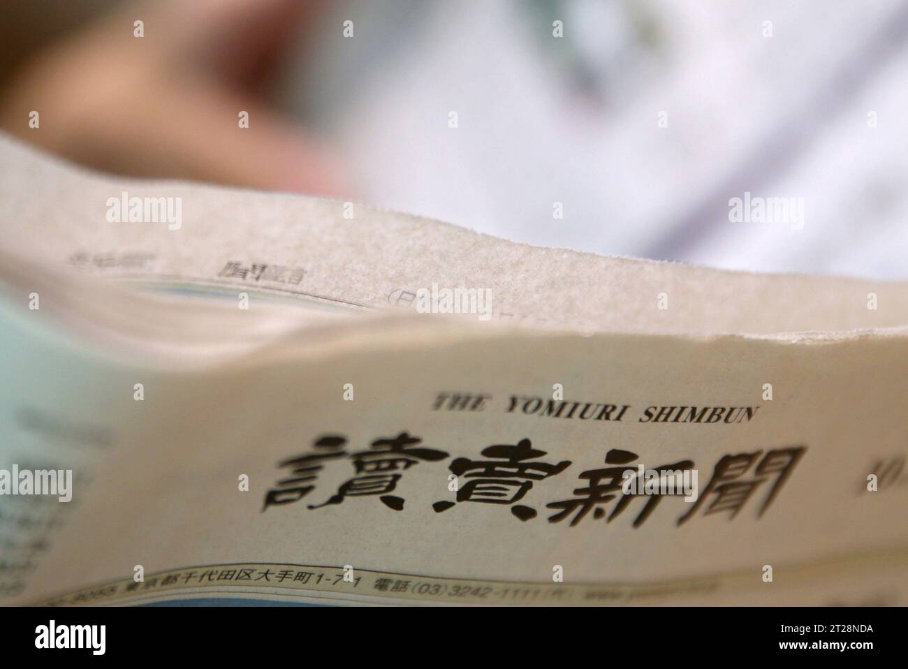 A man reads a Japanese newspaper, The Yomiuri Shimbun in Tokyo on Oct ...