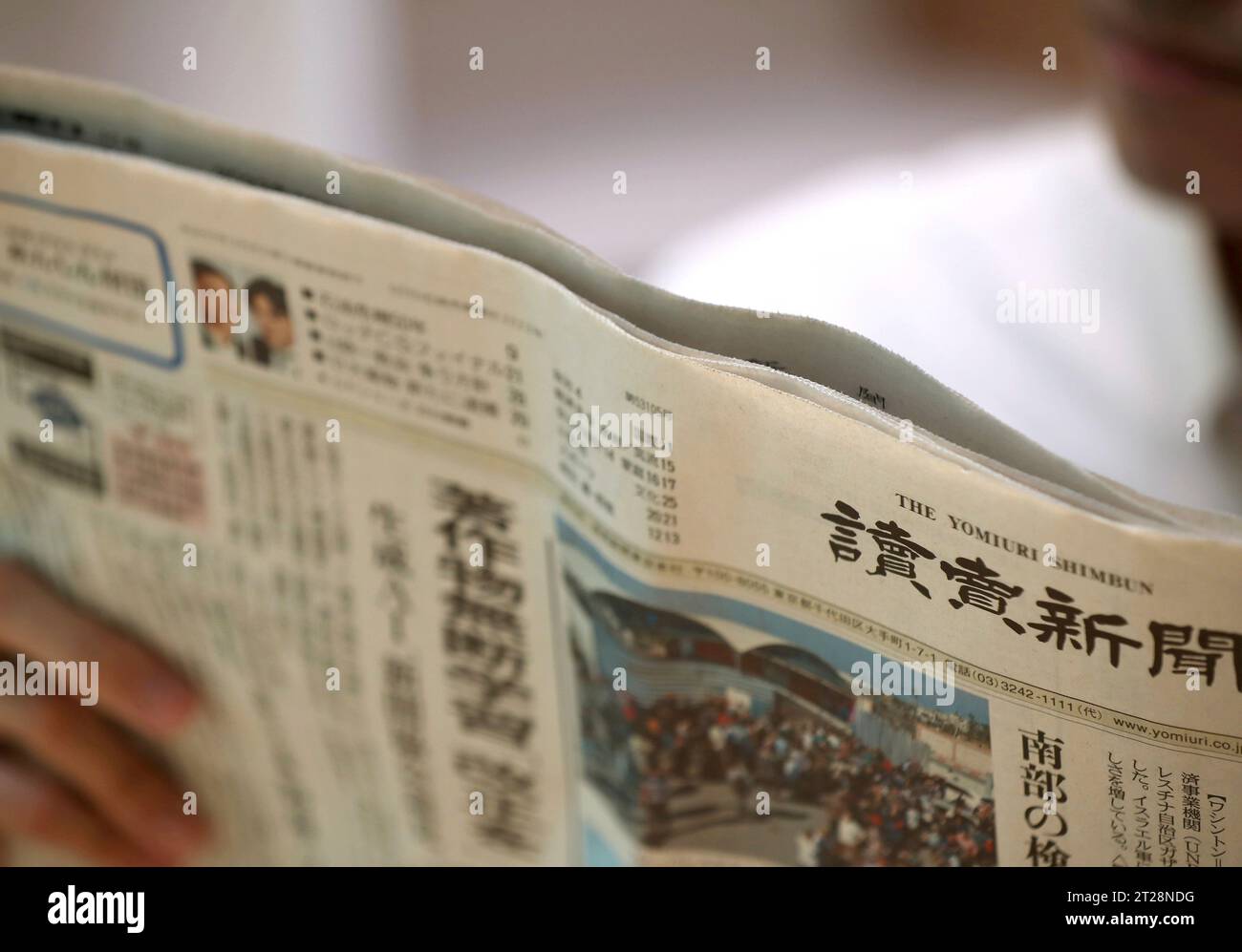 A man reads a Japanese newspaper, The Yomiuri Shimbun in Tokyo on Oct ...
