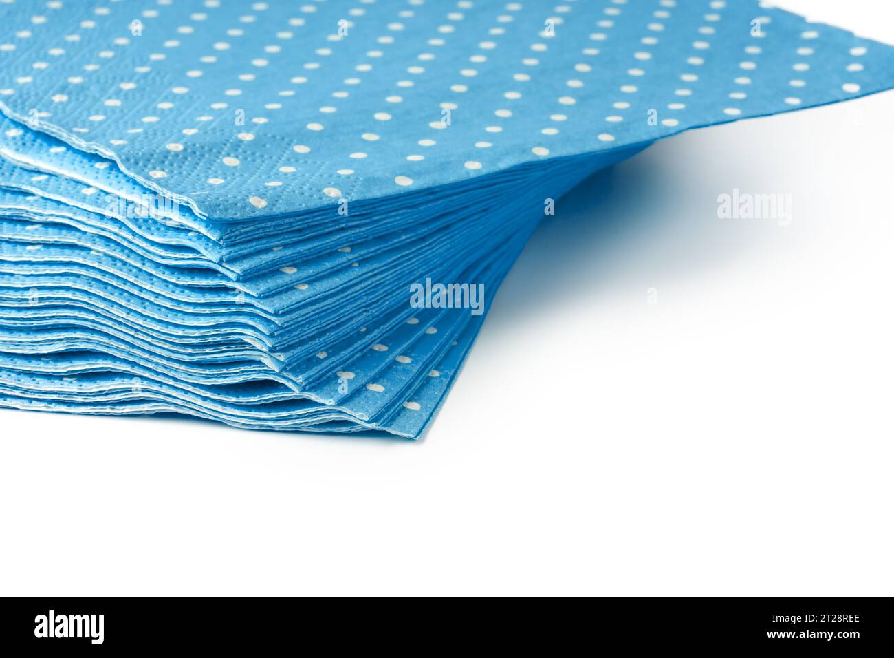 Stack of blue dotted paper napkins isolated on white Stock Photo - Alamy