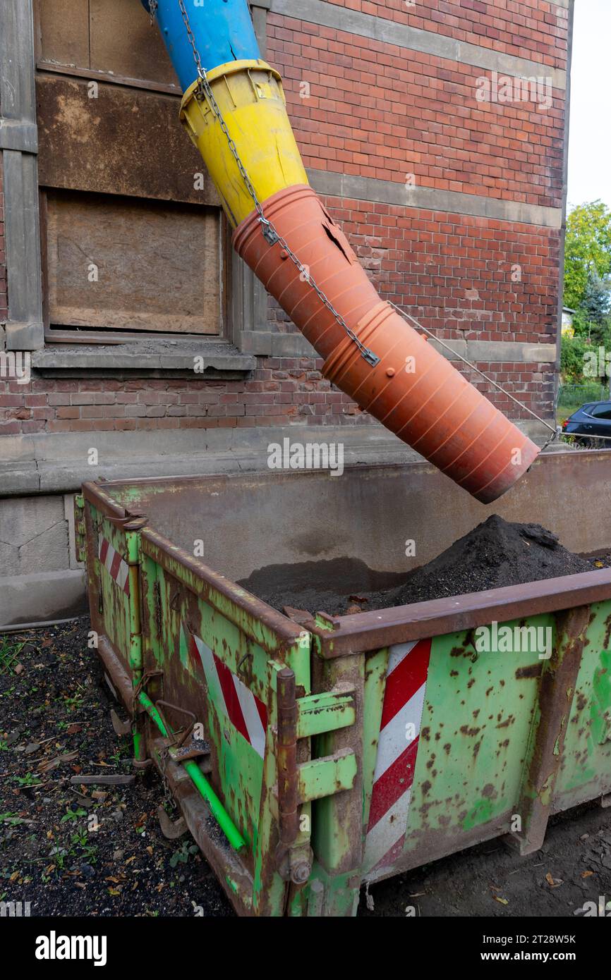 Rubble chute with container on a construction site for construction ...