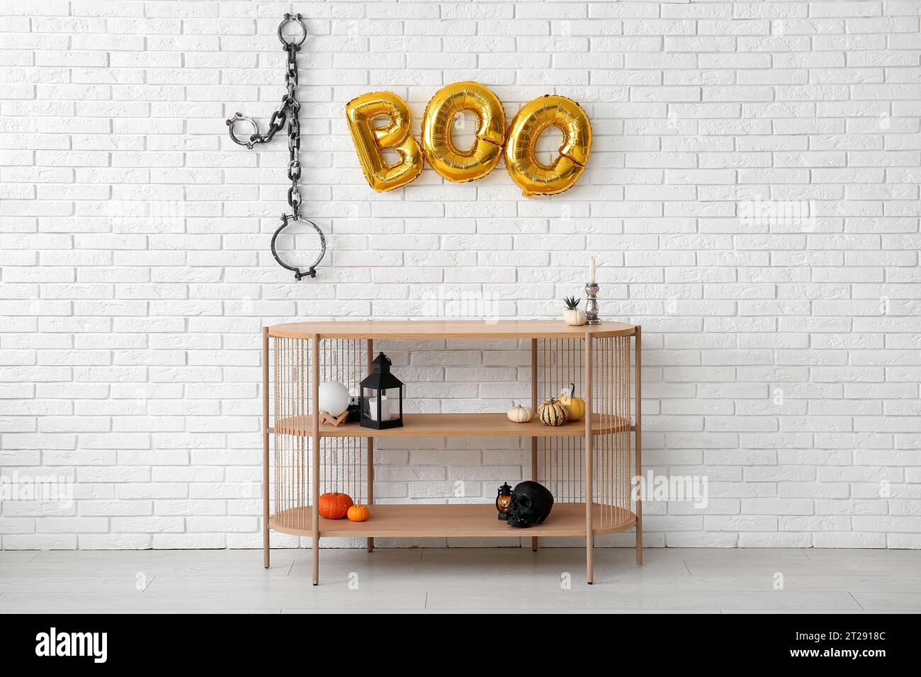 Shelving unit, text BOO made of balloons and shackles on light brick ...