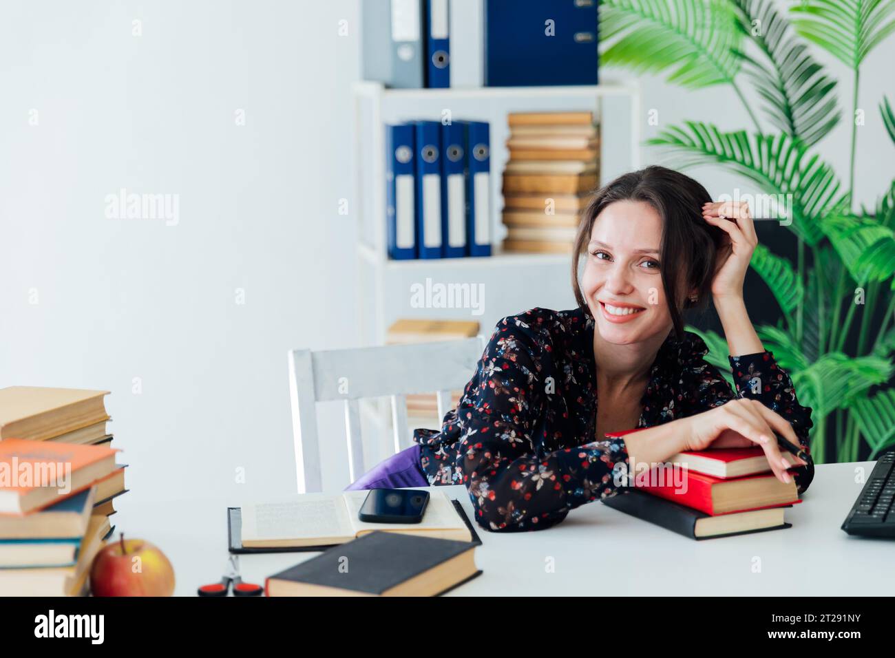 Beautiful business woman with books in office in office training ...