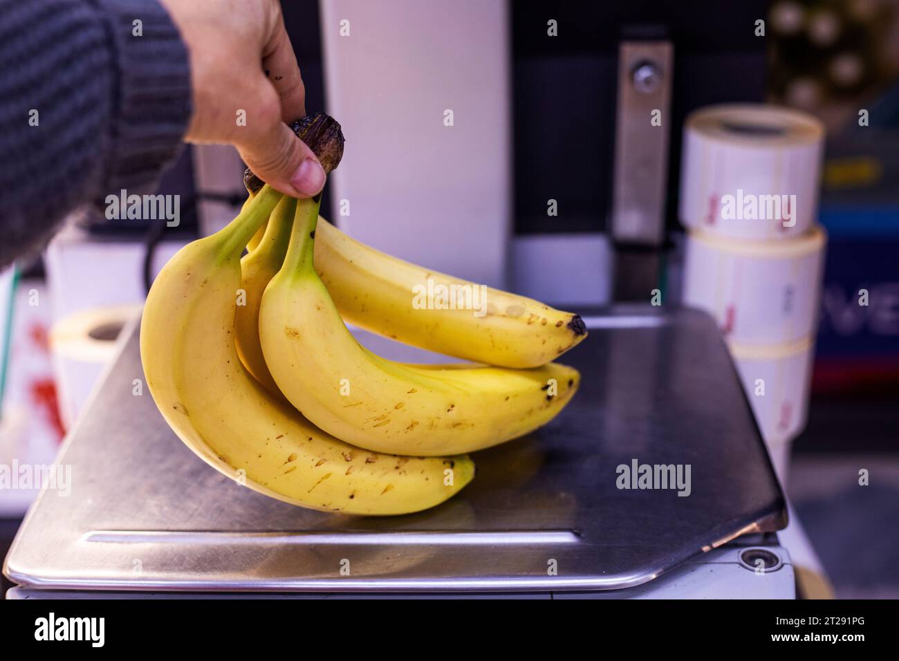 weighing a bunch of ripe yellow bananas on a supermarket scale Stock ...