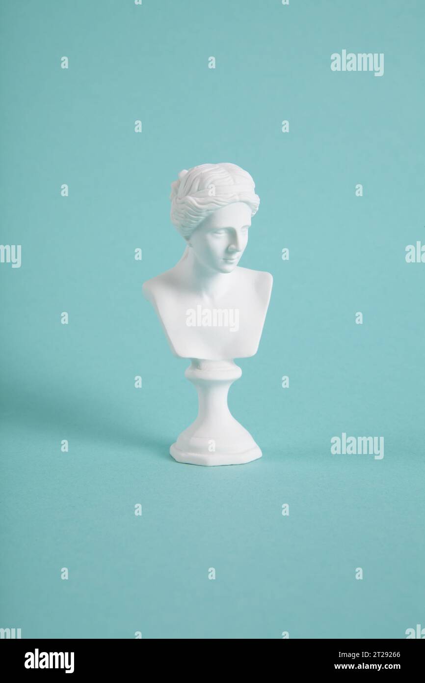 a white venus bust on a vivid turquoise background. A blend of classic ...