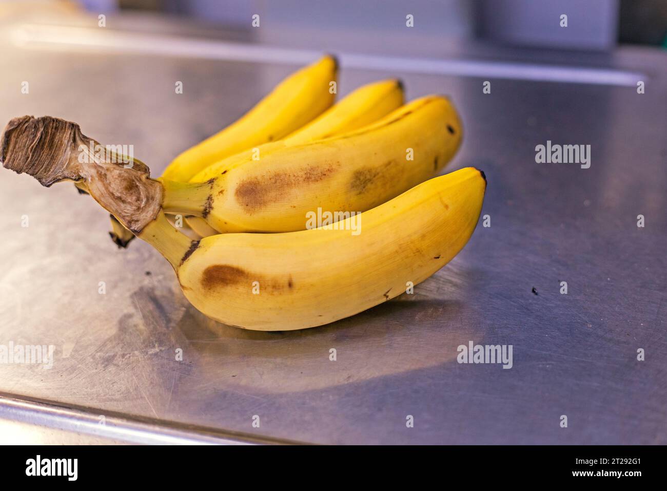 weighing a bunch of ripe yellow bananas on a supermarket scale Stock ...