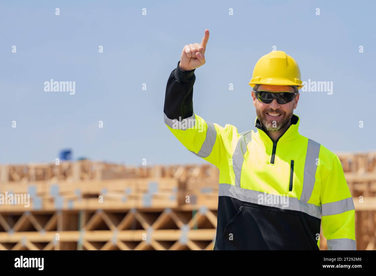 Construction worker at house under construction. Builder in building ...