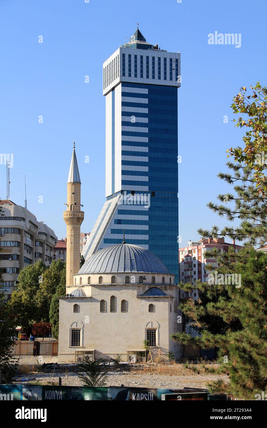 A multi-storey skyscraper and a small mosque in Konya. Bera Holding ...