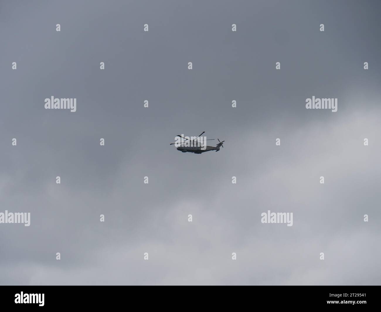 A helicopter in the gray sky at Saint Michael's Mount in Cornwall ...
