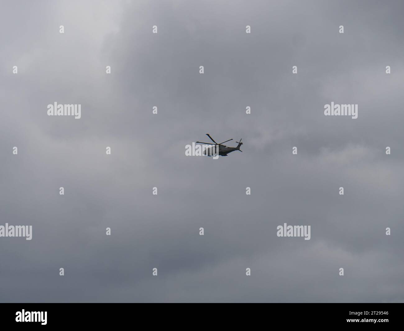 A helicopter in the gray sky at Saint Michael's Mount in Cornwall ...