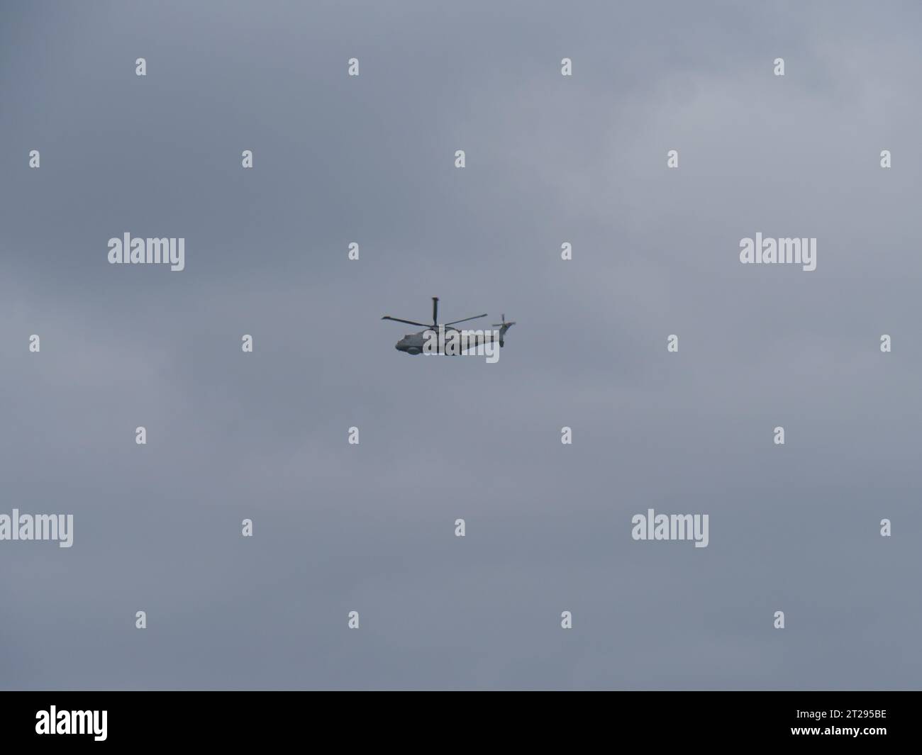 A helicopter in the gray sky at Saint Michael's Mount in Cornwall ...