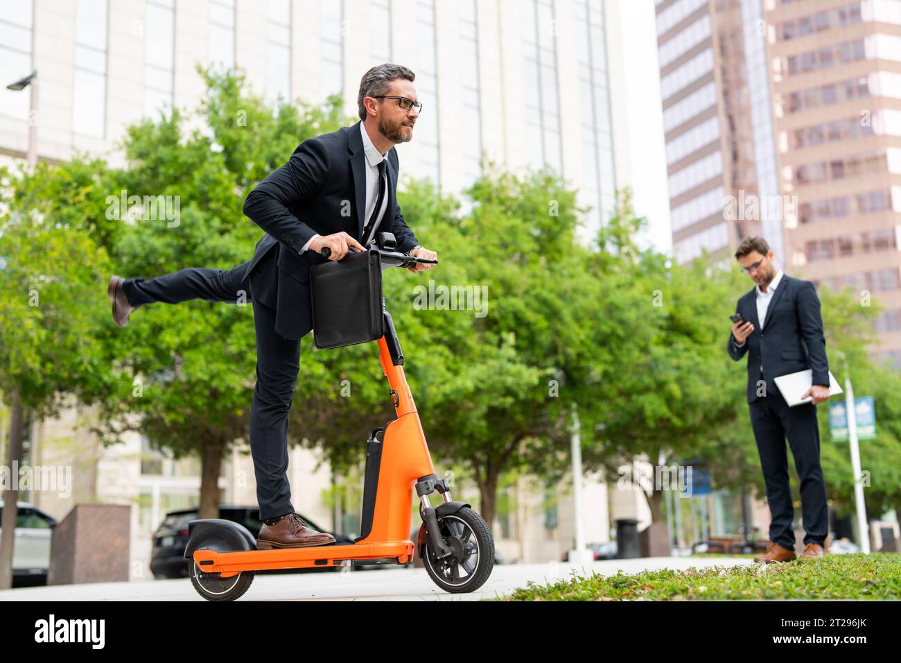 Funny excited business man on electric scooter on city street. Employee ...