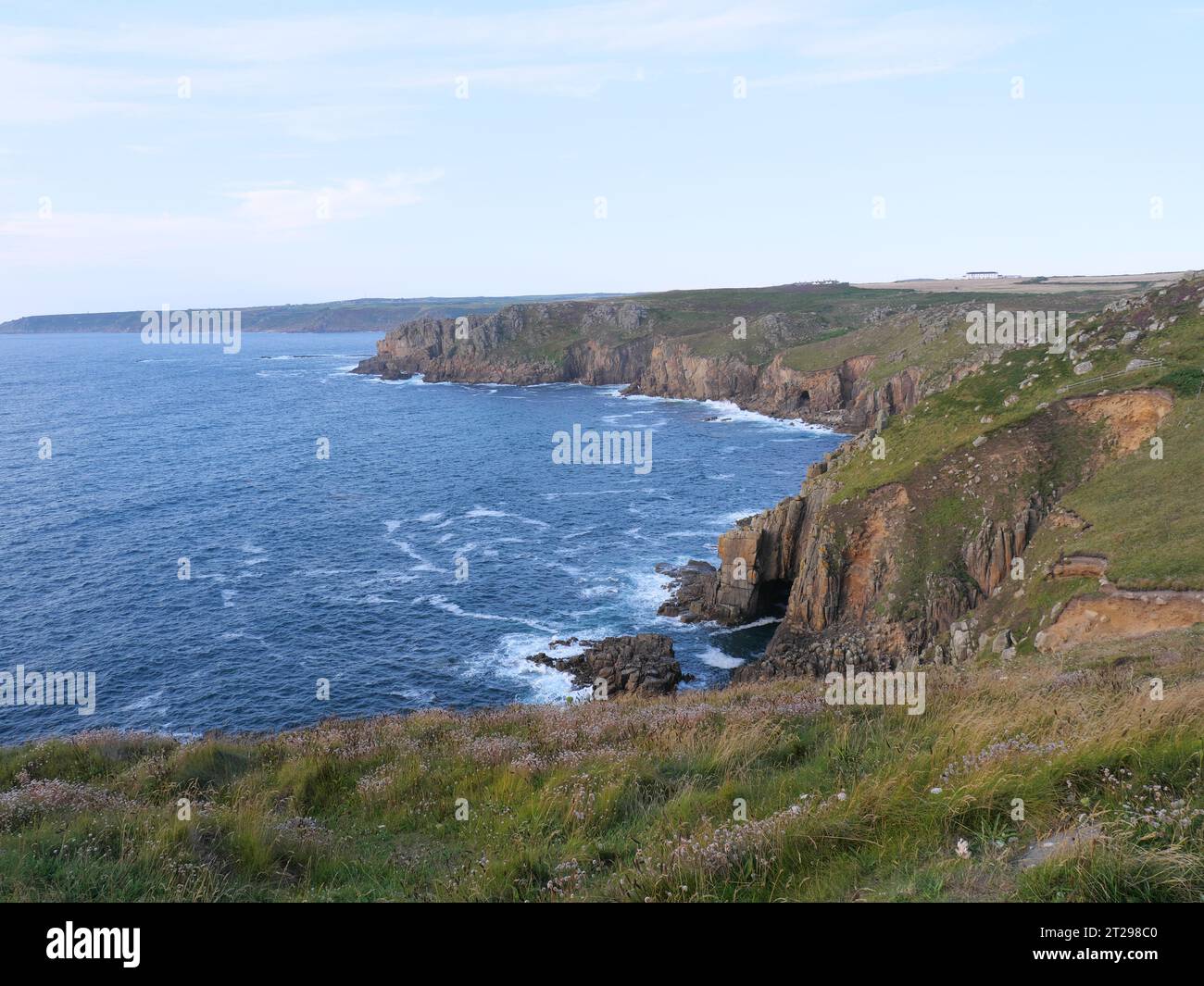 Steep cliffs with sparse vegetation and offshore rocks of Land's End ...
