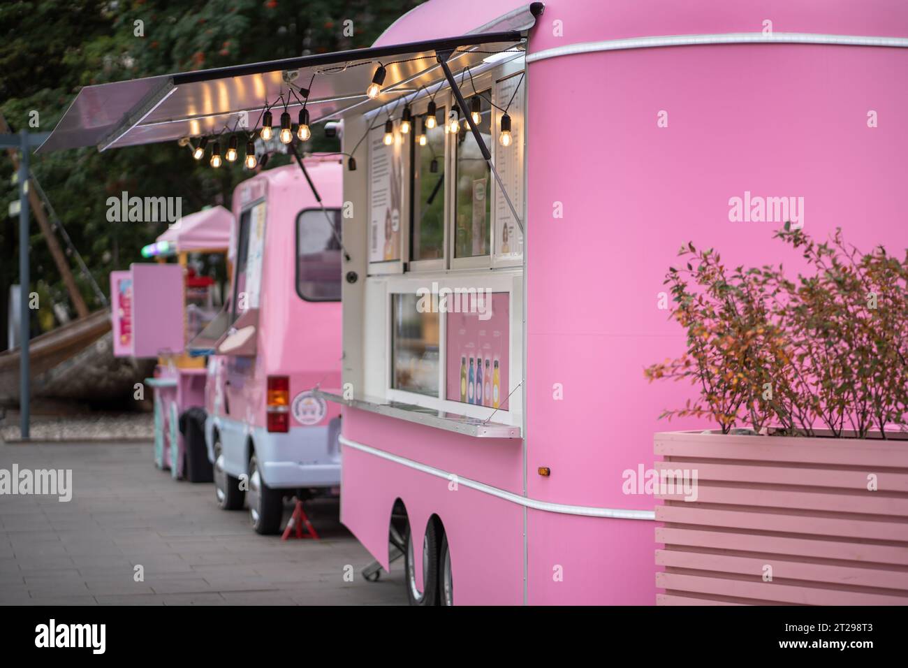 Pink ice cream vans on street in city, mobile fair trade with food ...