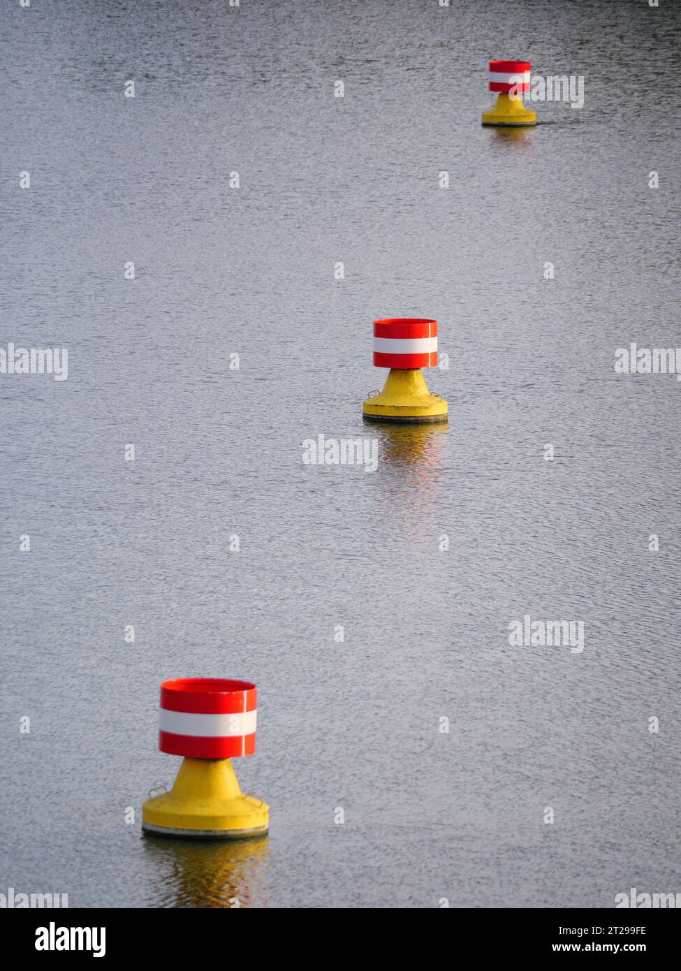 Red-yellow,white buoys drifting in the current on the water surface of ...