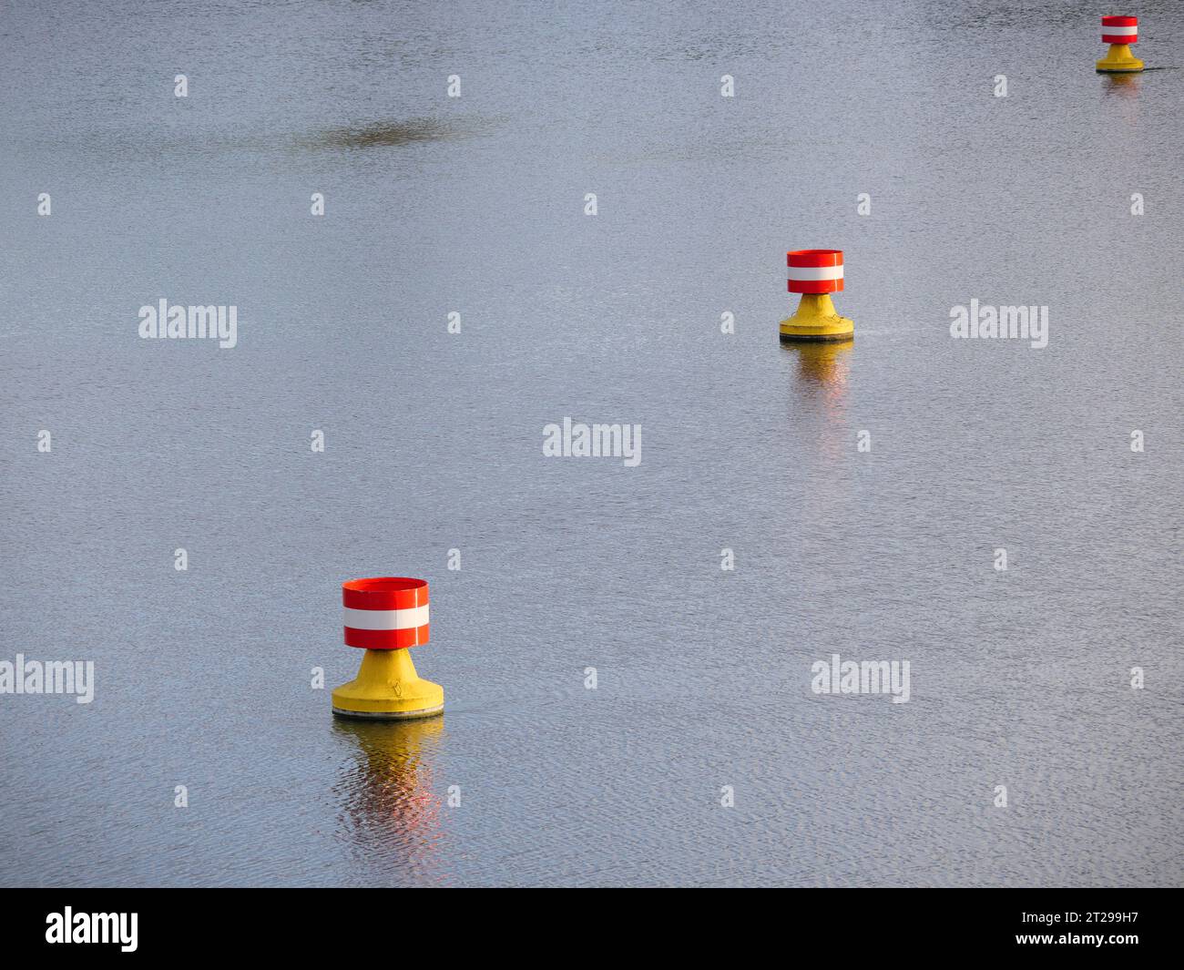 Red-yellow,white buoys drifting in the current on the water surface of ...