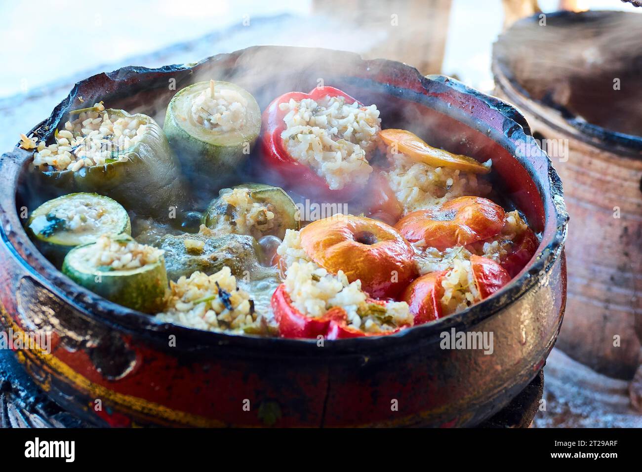 Gemista, steaming stuffed tomatoes, peppers and courgettes in bowl ...