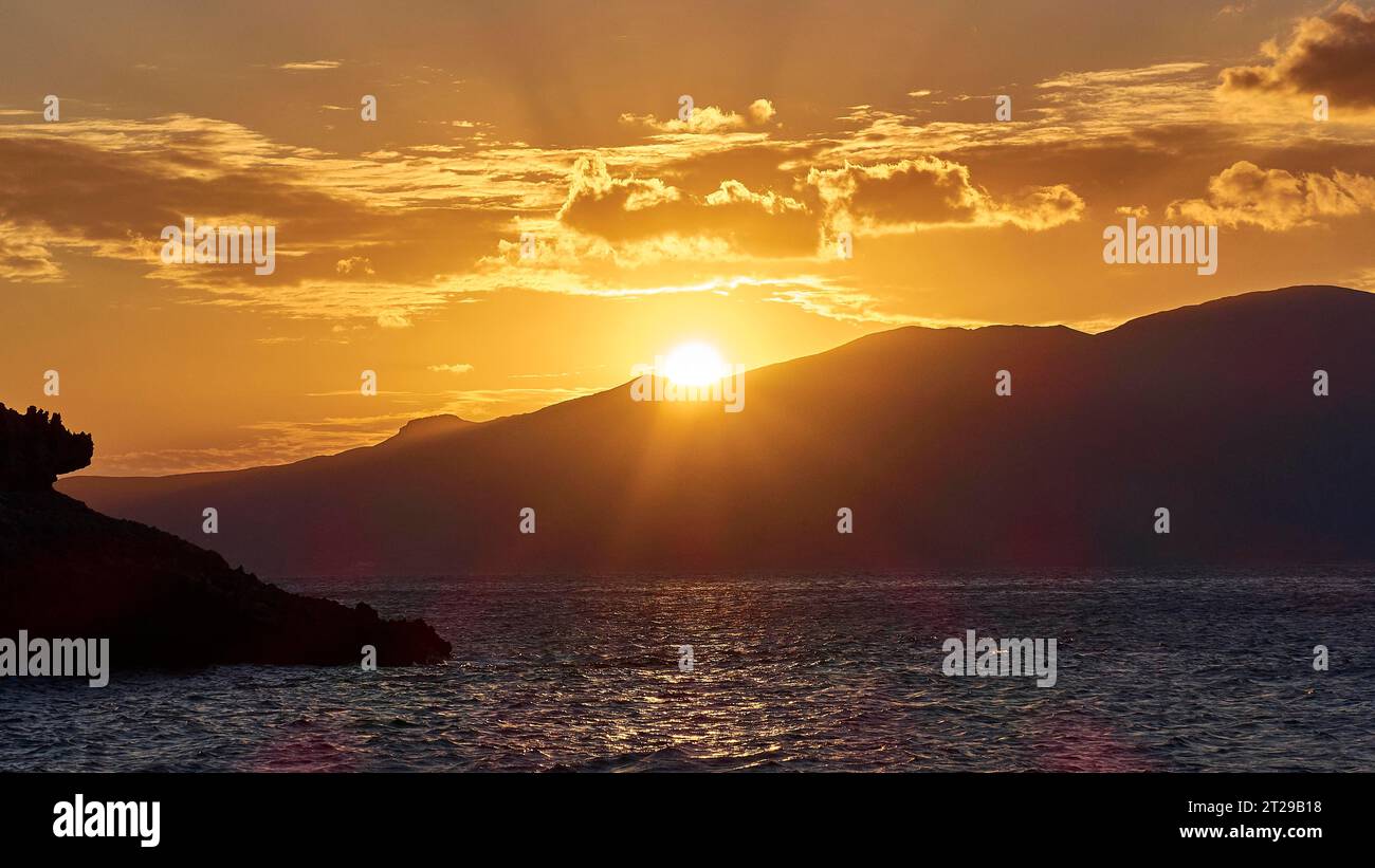 Sunset, sun behind Gramvoussa peninsula, cloudy orange sky, Ravdoucha ...