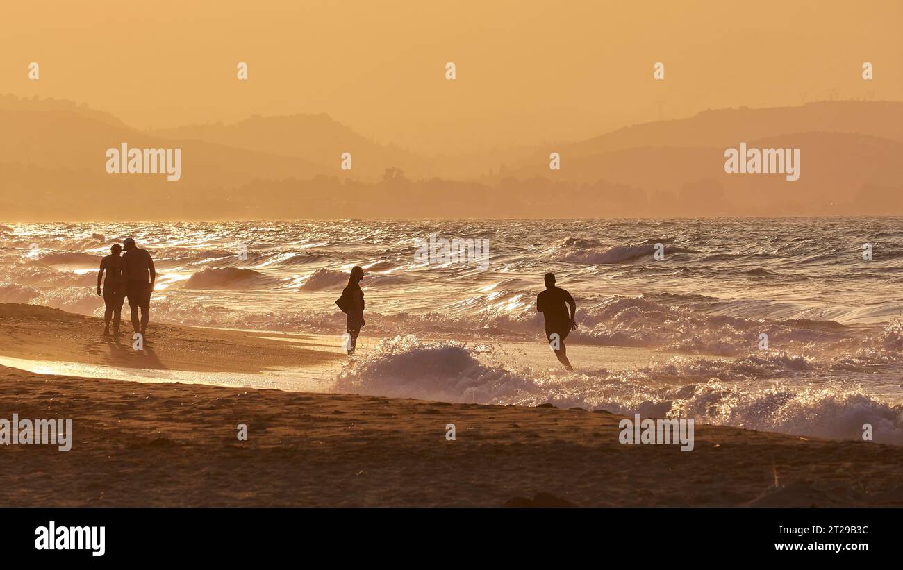 Evening light, sunset, copper-coloured light, strong surf, waves ...