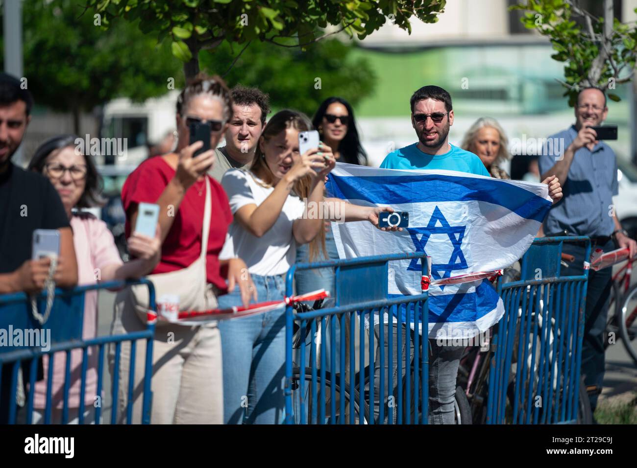 People stand along the motorcade route as President Joe Biden travels ...