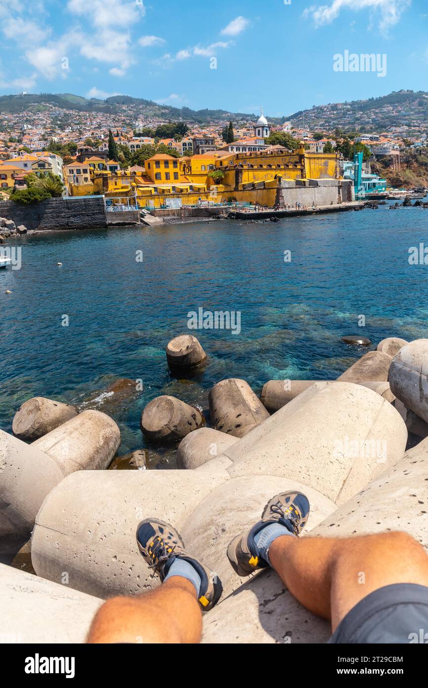 Sitting looking at yellow fort by the sea from Forte de Sao Tiago on ...