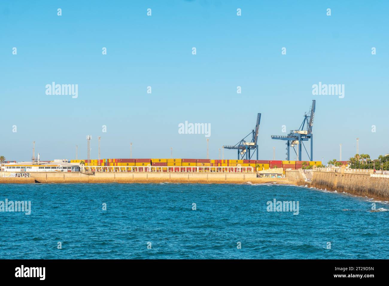 Commercial maritime and industrial cargo port with cranes from the city ...
