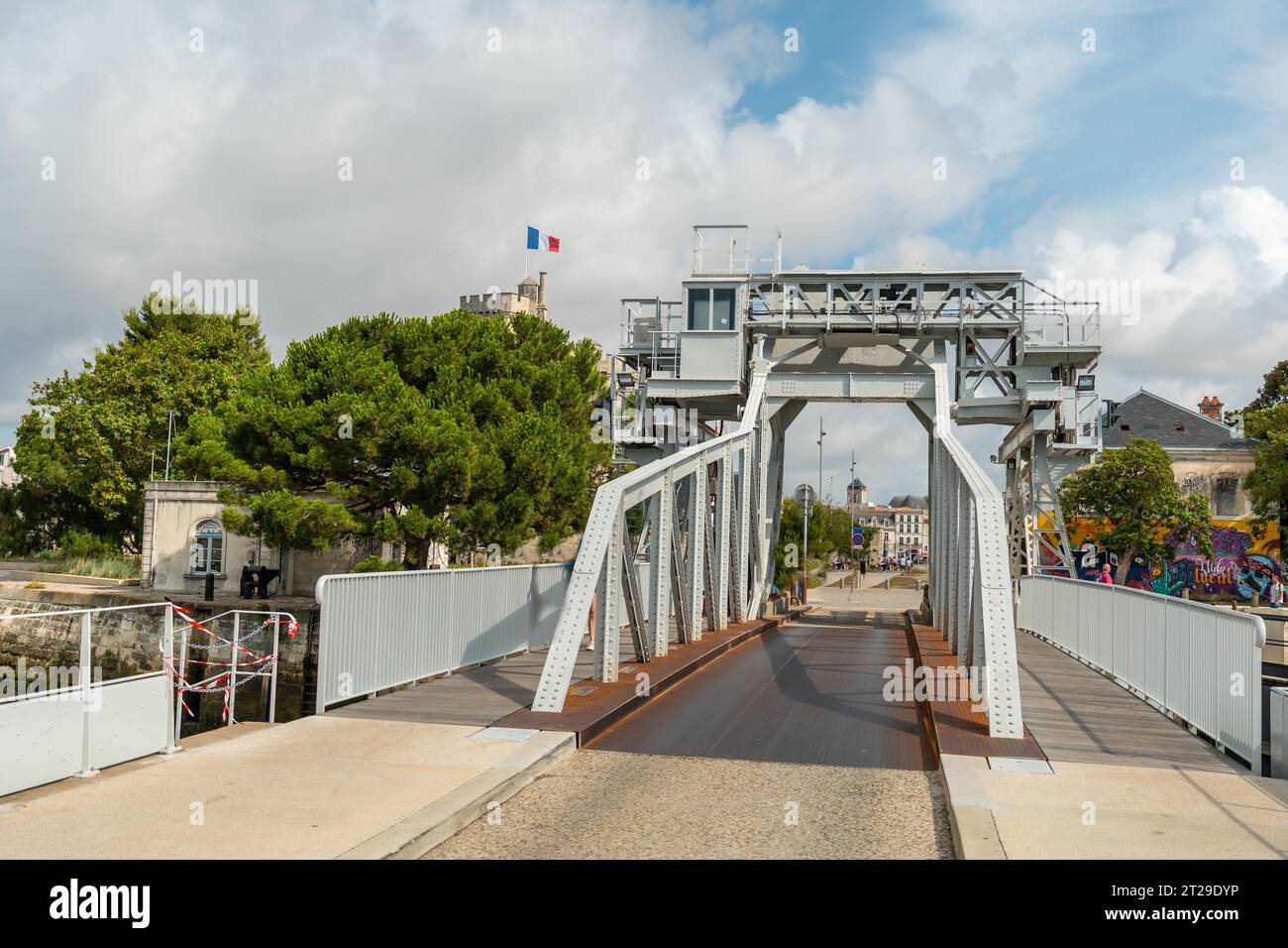A bridge in the marina next to the towers of the fort in La Rochelle ...
