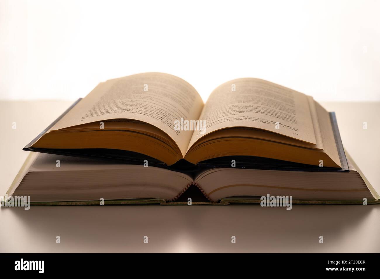 Open book and pages turned, backlit, on a white background. Passion for ...