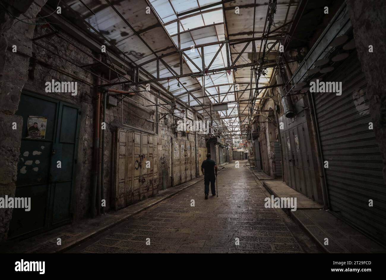 Nablus, Palestinian Territories. 18th Oct, 2023. A man walks past ...