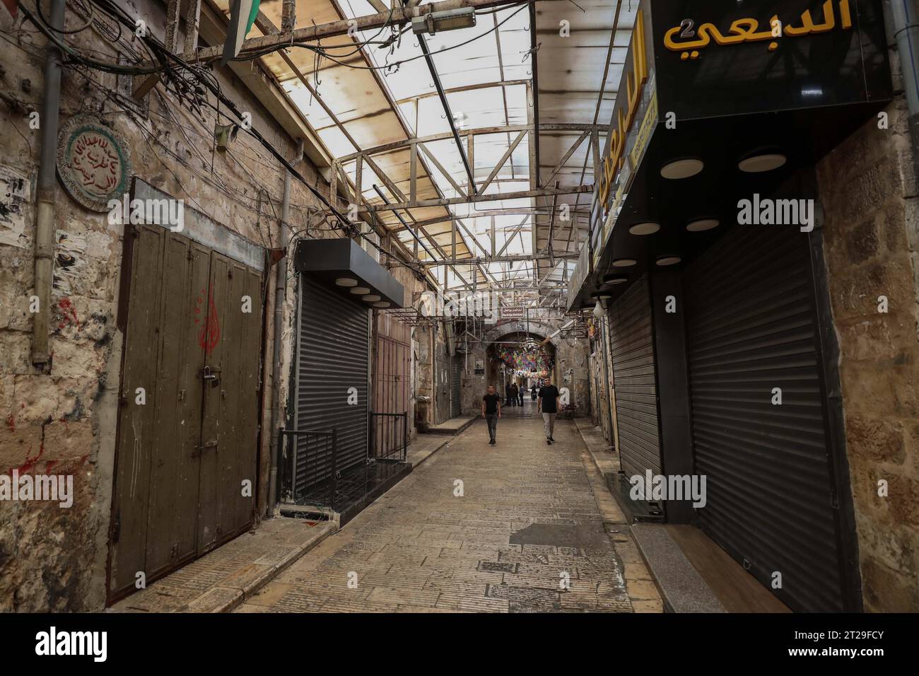 Nablus, Palestinian Territories. 18th Oct, 2023. People walk past ...