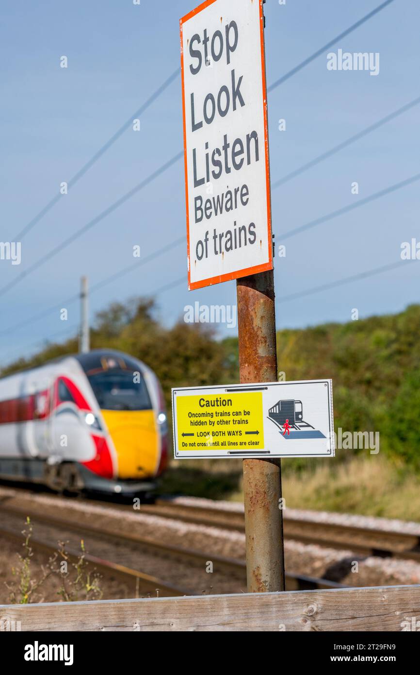 Caution, Look both ways and Stop Look Listern warning signs at level ...