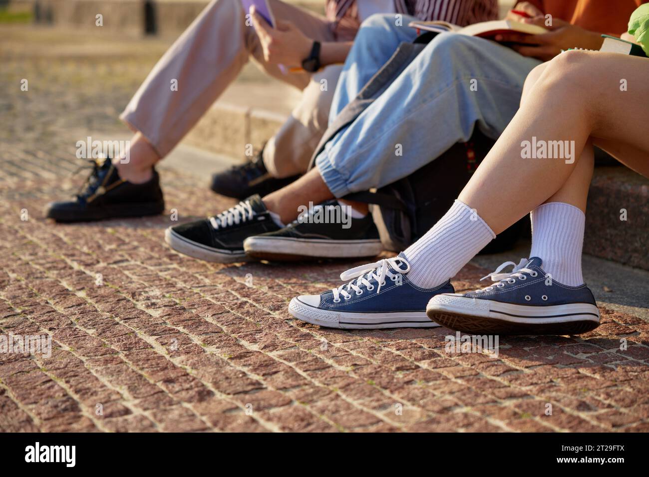 Legs of university students doing homework Stock Photo - Alamy