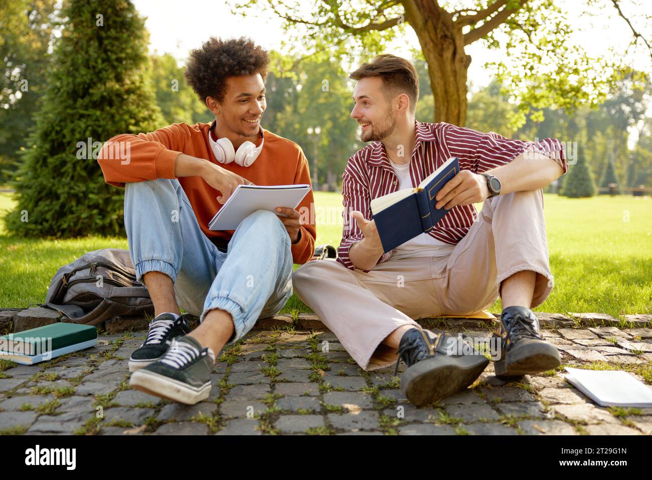 Two friend students talking together discussing ideas Stock Photo - Alamy