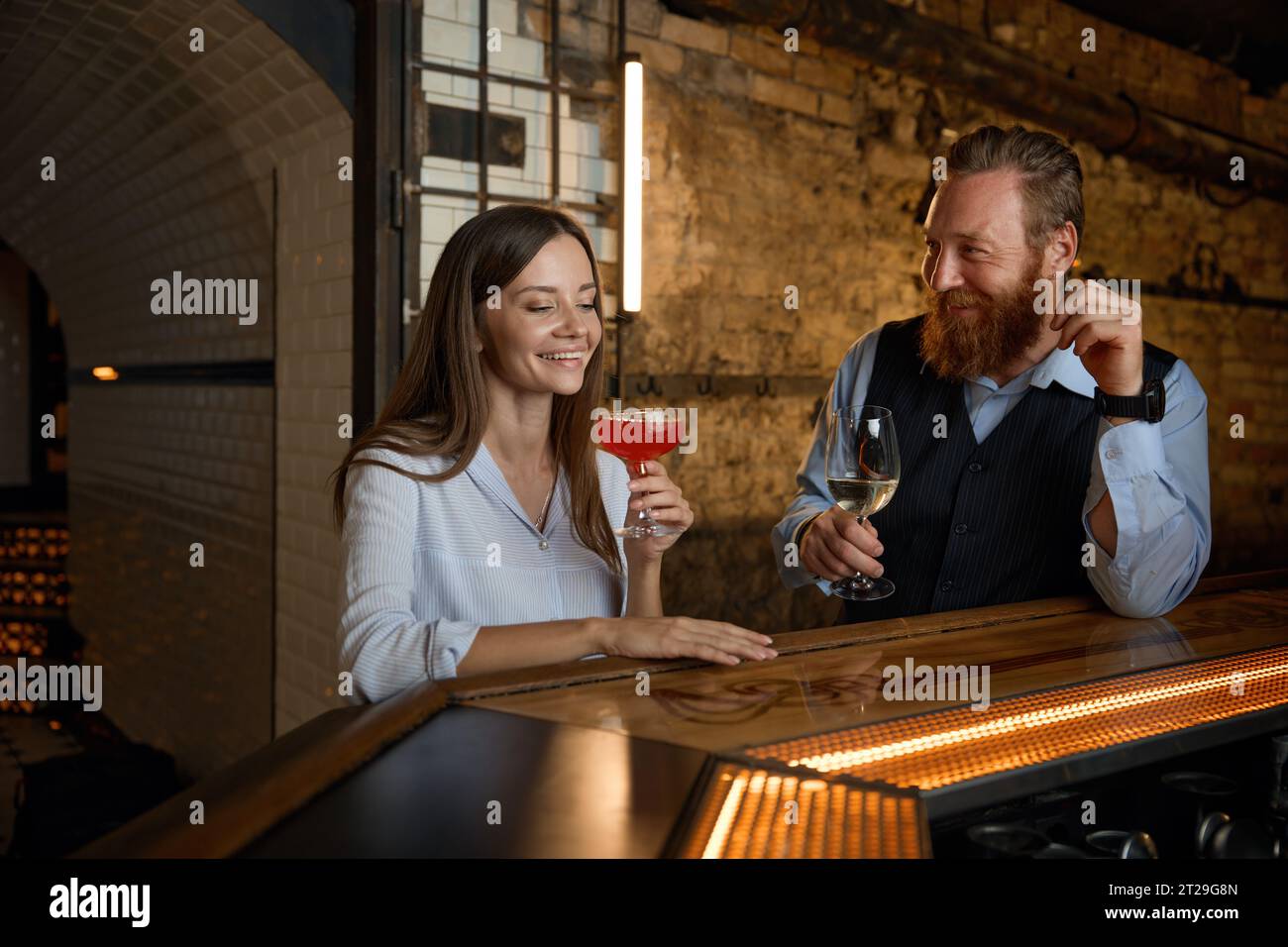 Man picking up woman in bar starting nice conversation Stock Photo - Alamy