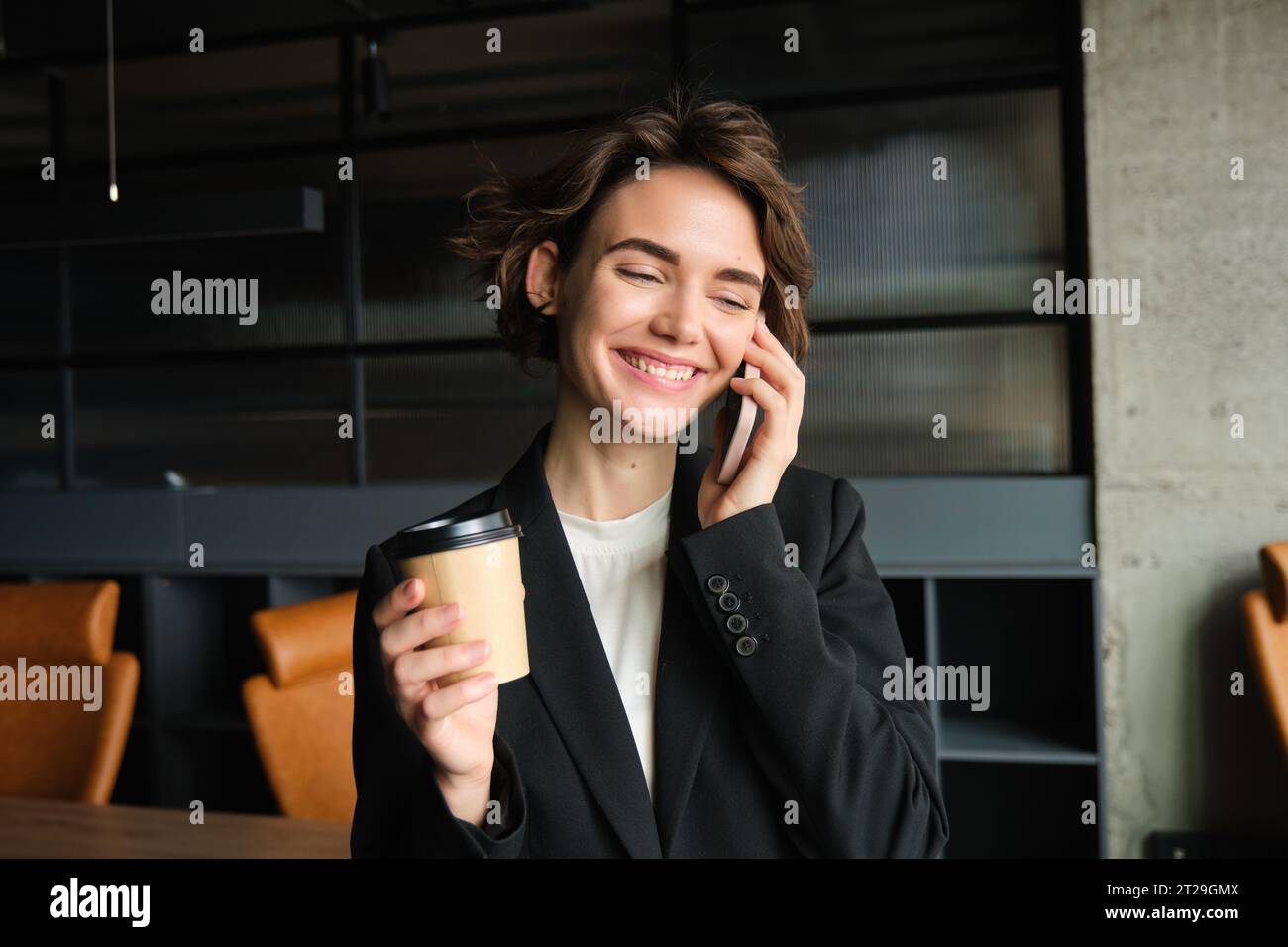 Image of businesswoman calling client on smartphone, answers a phone ...