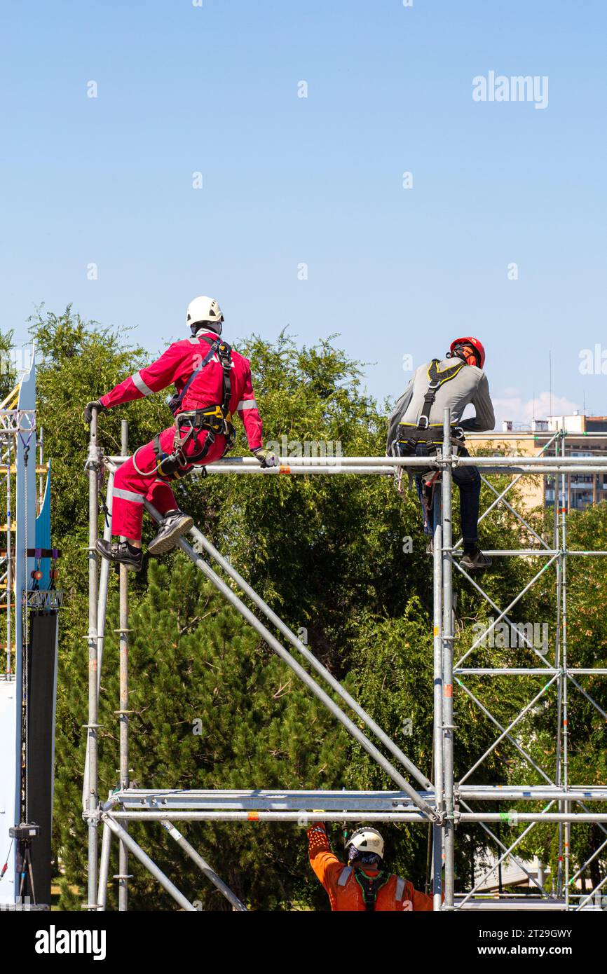The workers assemble a metal structure at height Stock Photo - Alamy