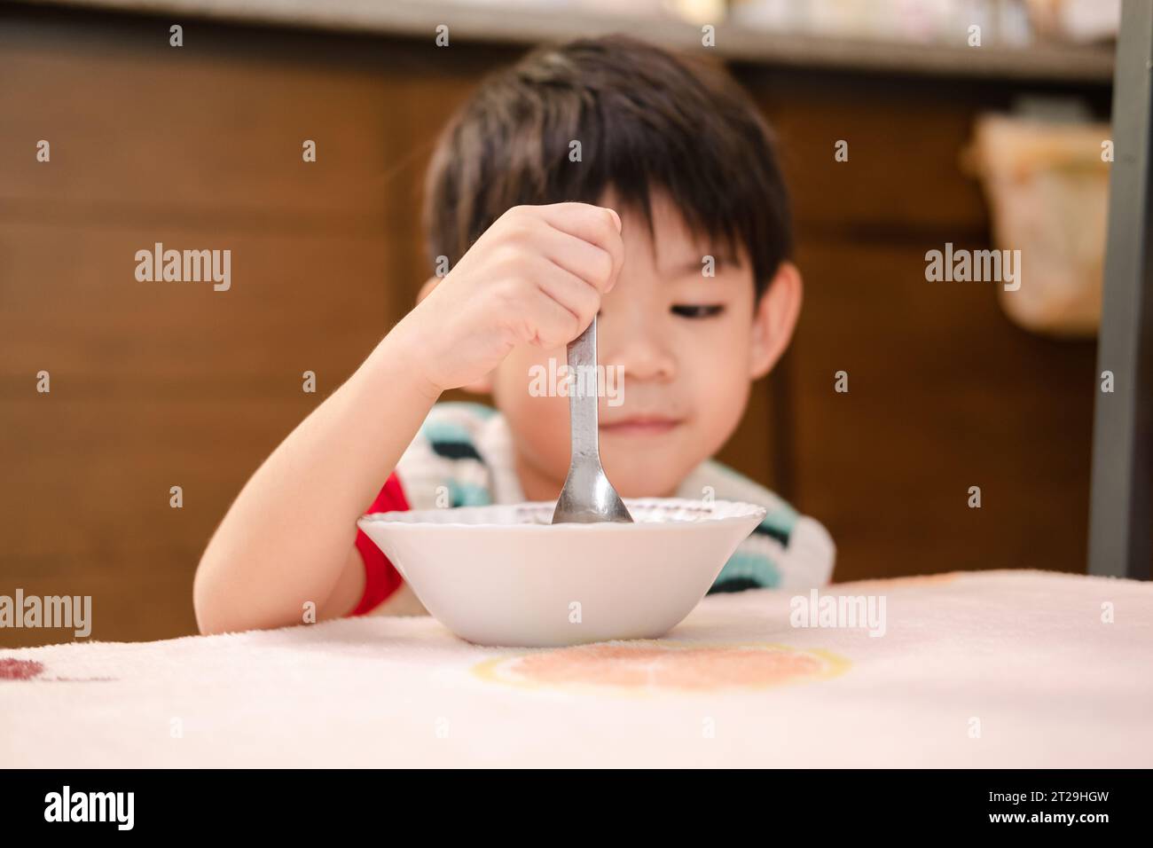 The face of an Asian child eating rice Stock Photo - Alamy