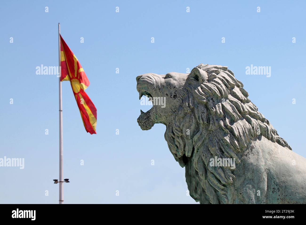 View of the national macedonian flag and lion sculpture. Skopje, North ...