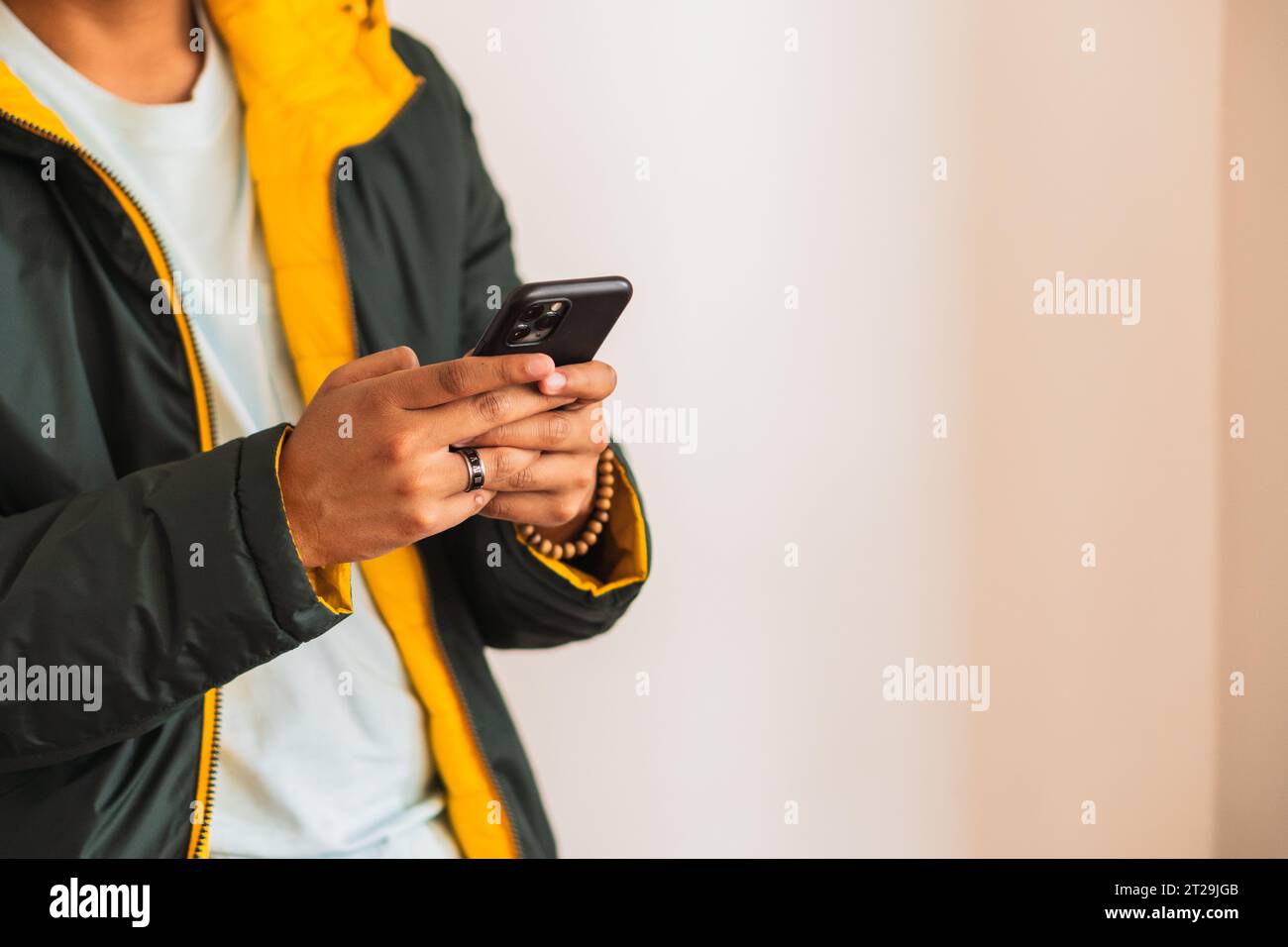 Anonymous young ethnic male in formal apparel with cellphone and ...
