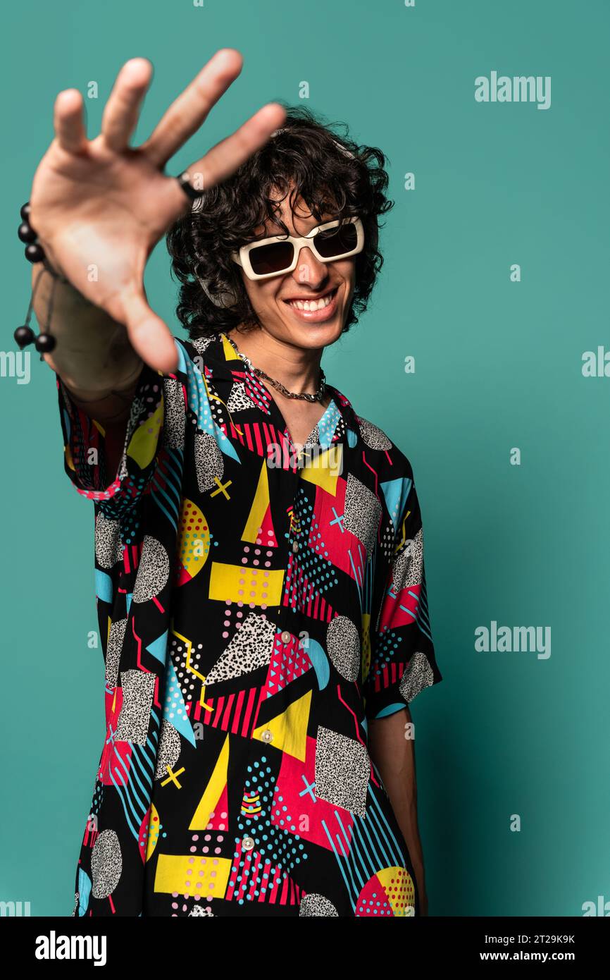 Funky young smiling Latin American male with headphones sunglasses ...