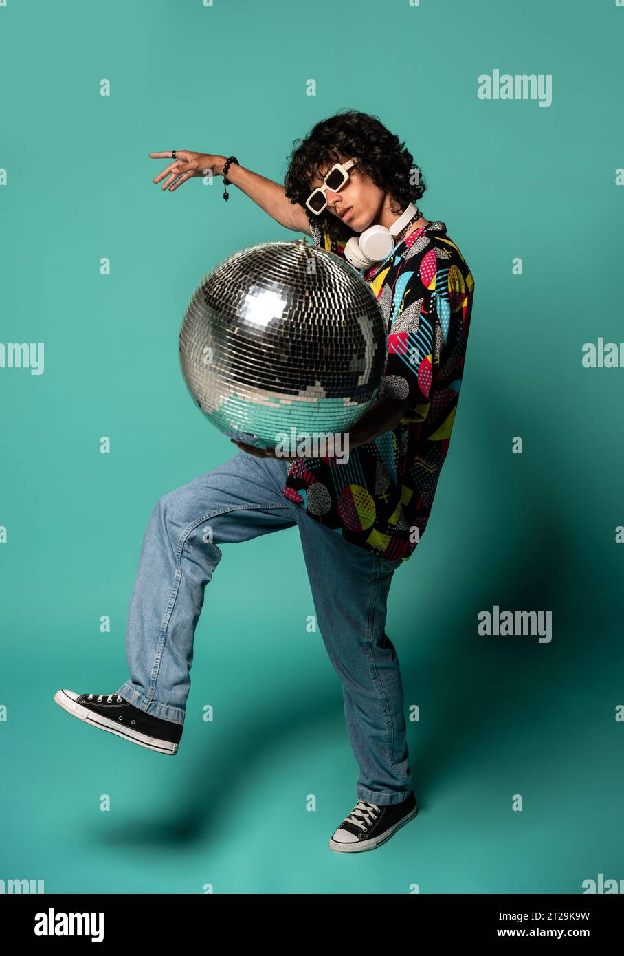 Funky young Latin American male with sunglasses looking away while ...