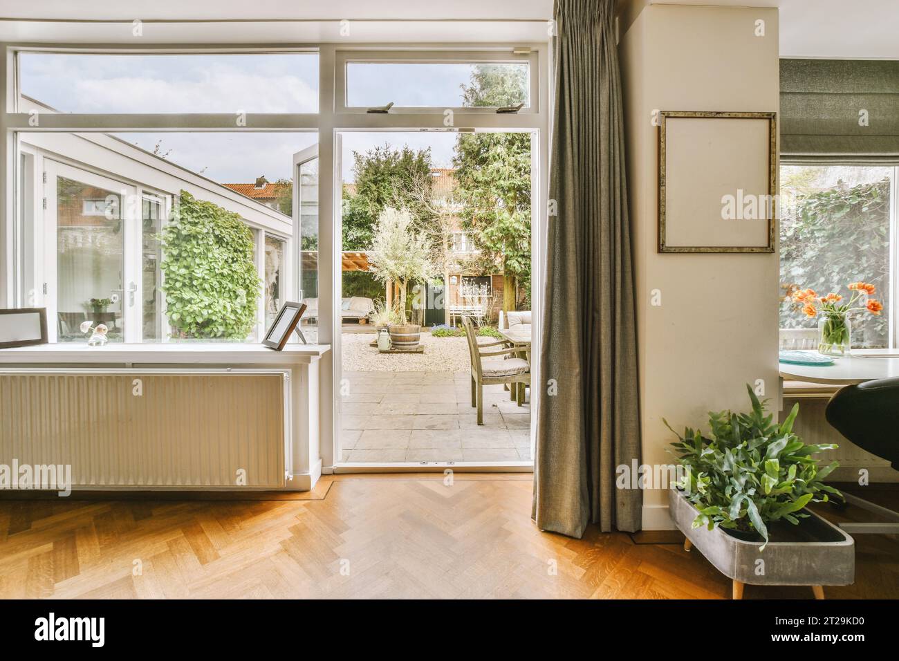 Modern living room with sliding glass doors leading to backyard patio ...